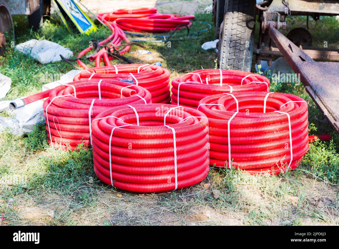 Red plastic hoses neatly rolled into a ball on the construction site ...