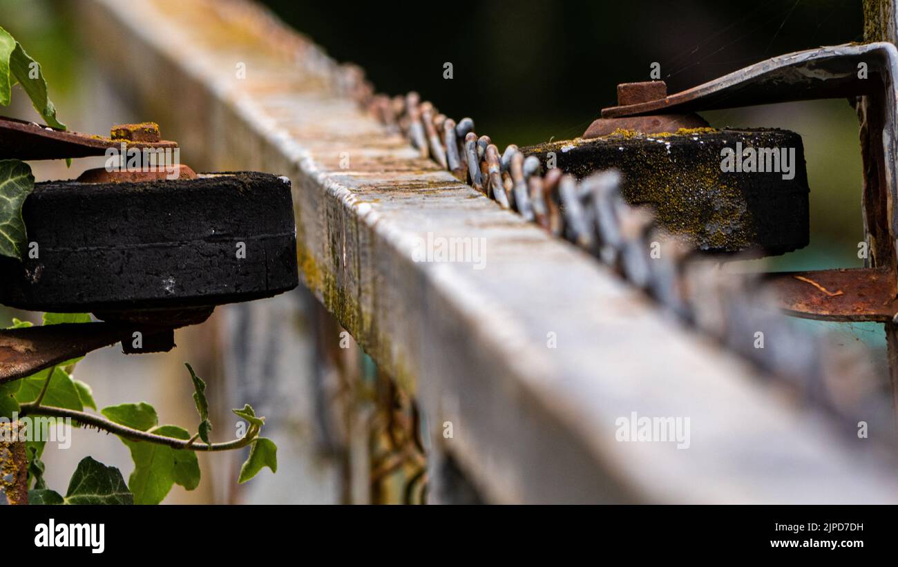 A metal fence with a rolling gate on a blurry background Stock Photo ...