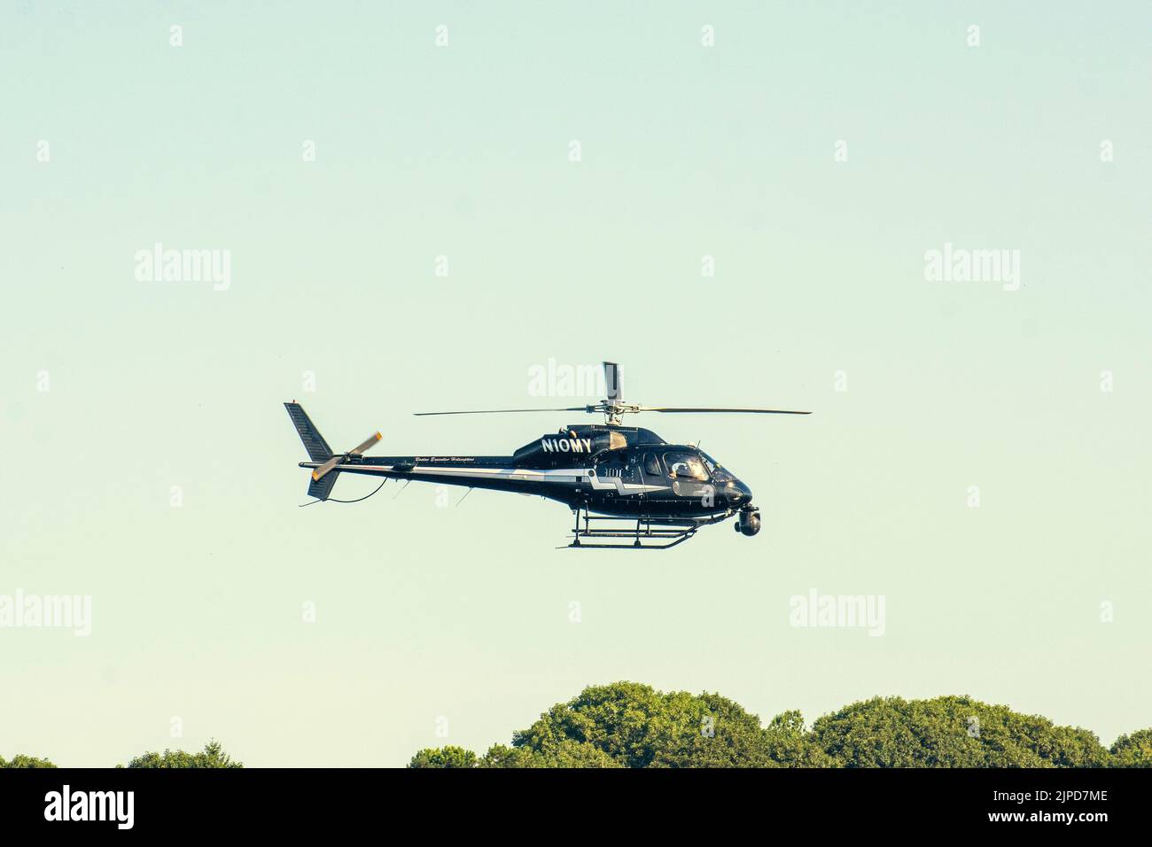 Private helicopter flying over the ocean waters Stock Photo - Alamy