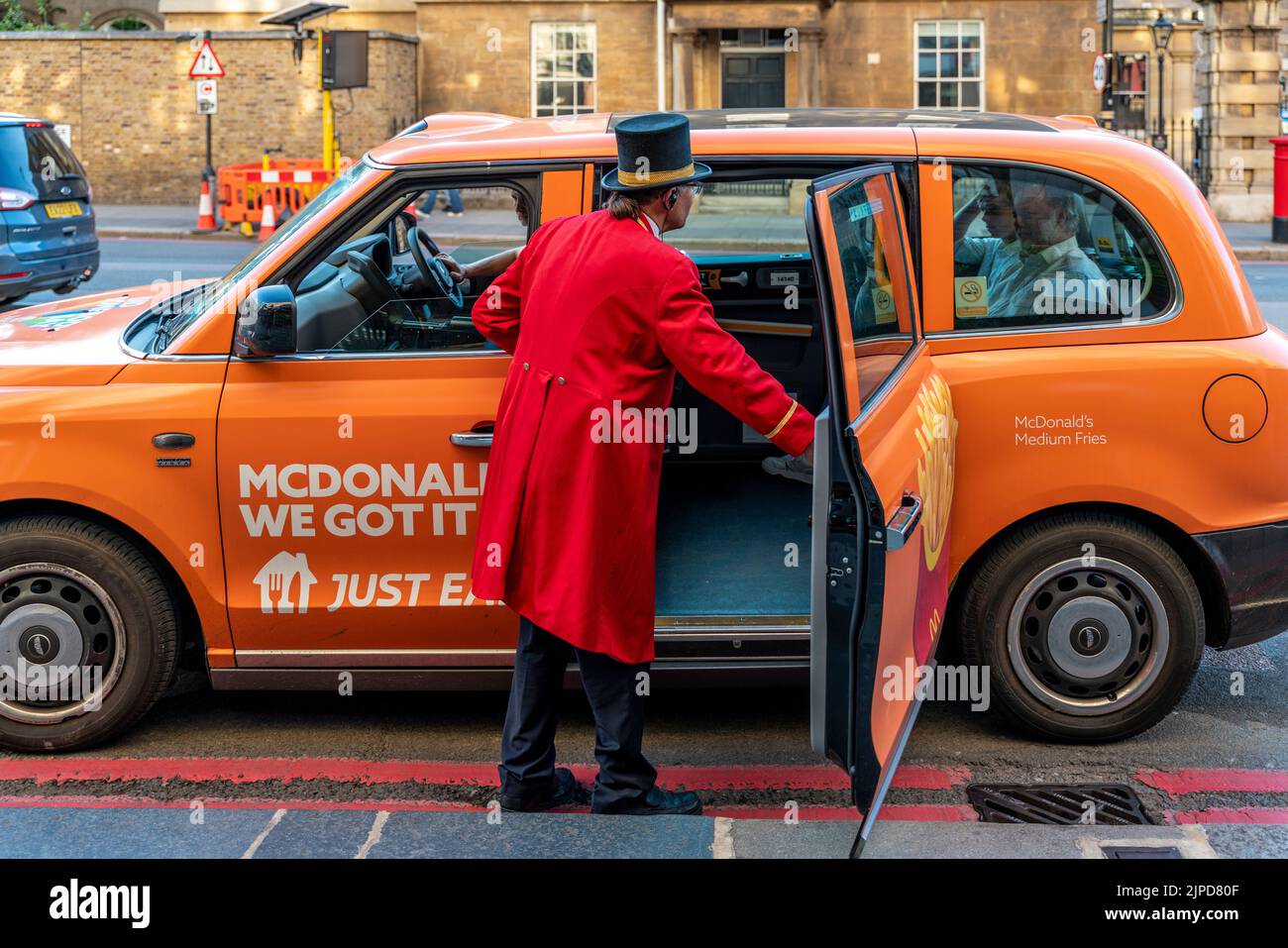 A Hotel Doorman Opens A Taxi Door For Some Hotel Guests, Victoria ...