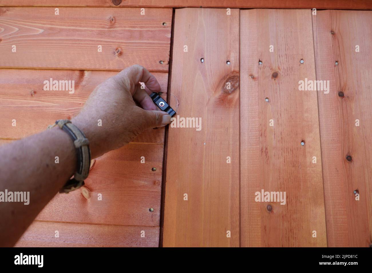 POV hand opening or closing a new wooden shed door Stock Photo - Alamy