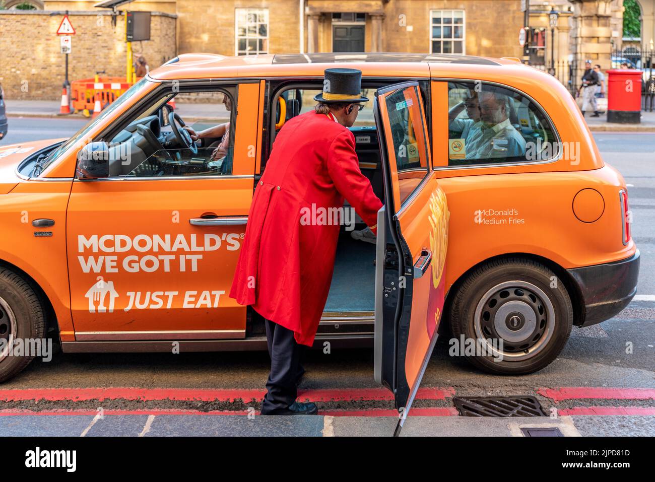 A Hotel Doorman Opens A Taxi Door For Some Hotel Guests, Victoria ...