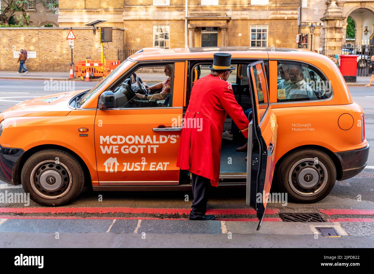 A Hotel Doorman Opens A Taxi Door For Some Hotel Guests, Victoria ...