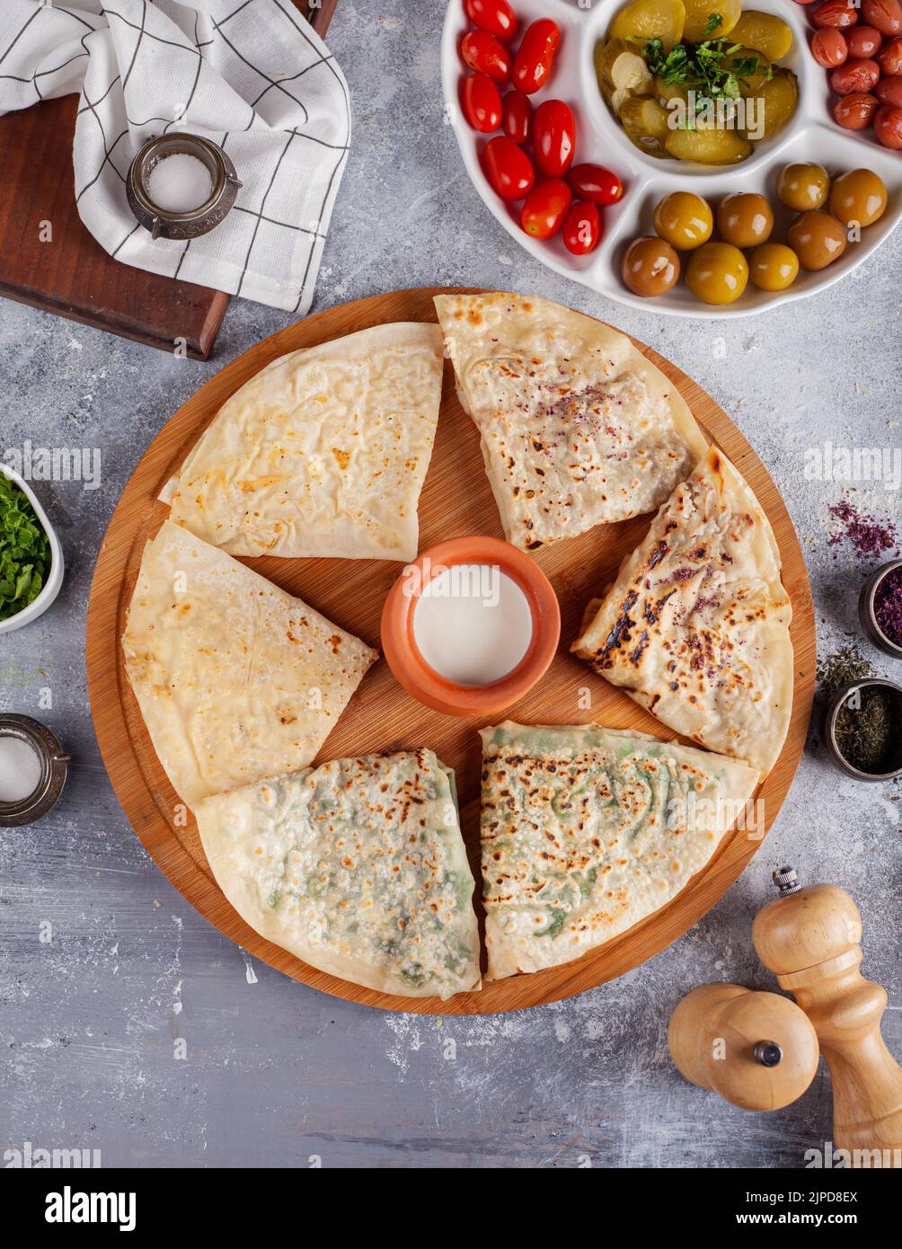 A vertical shot of tortillas with different fillings and side dishes ...