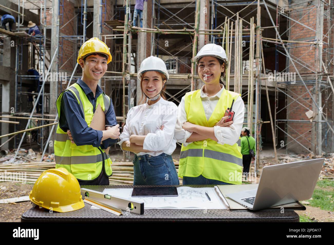Structural engineer and architect discussing and working with blueprints at the outdoors ...