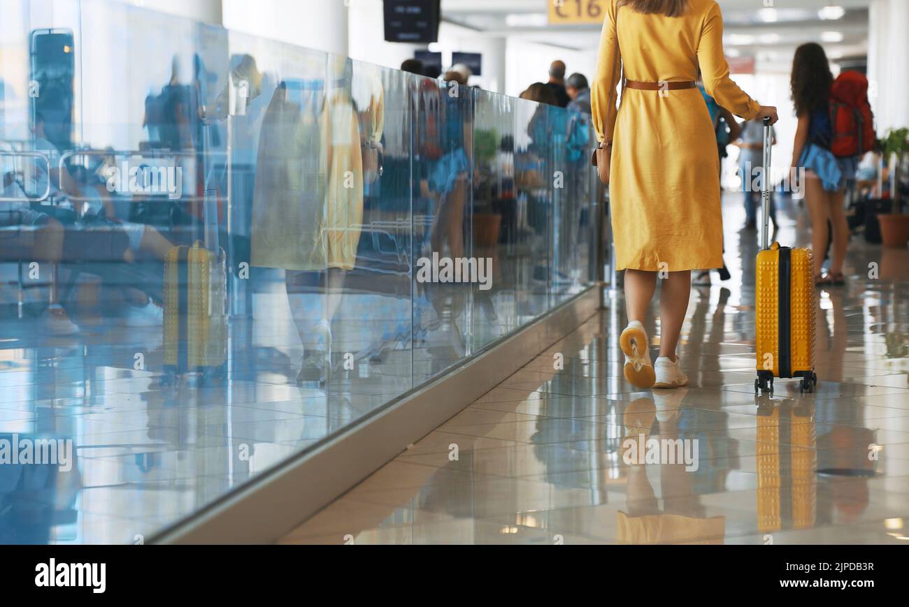 Woman walking in airport terminal. Back view Stock Photo - Alamy