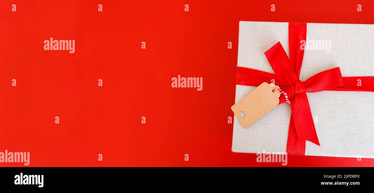 Red banner with gift box tied red ribbons Stock Photo - Alamy