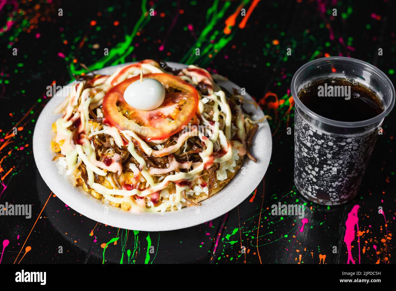 typical dish of colombian street food, arepa with chicken and shredded ...