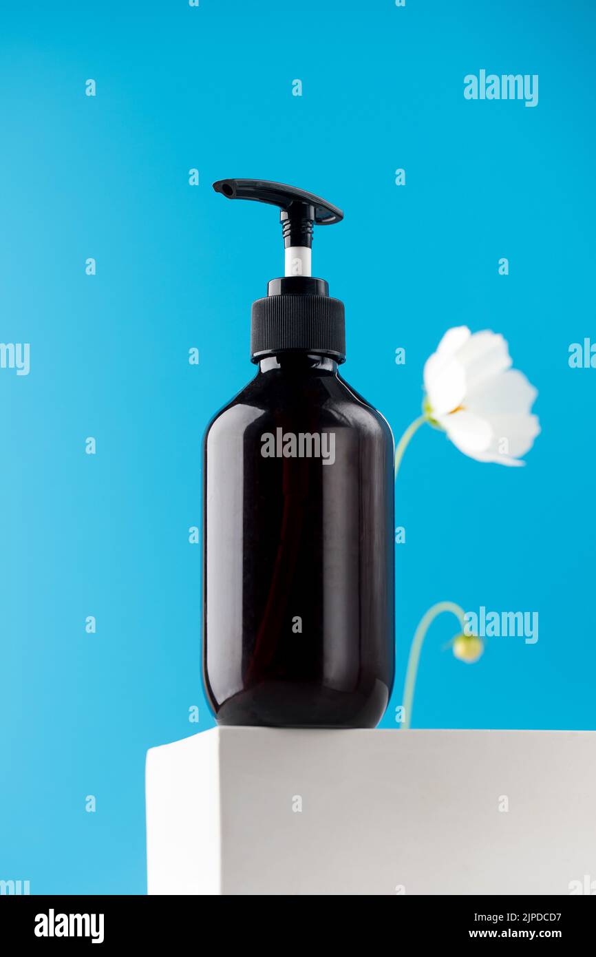 Mockup of a brown dispenser with a cosmetic product with a place for ...