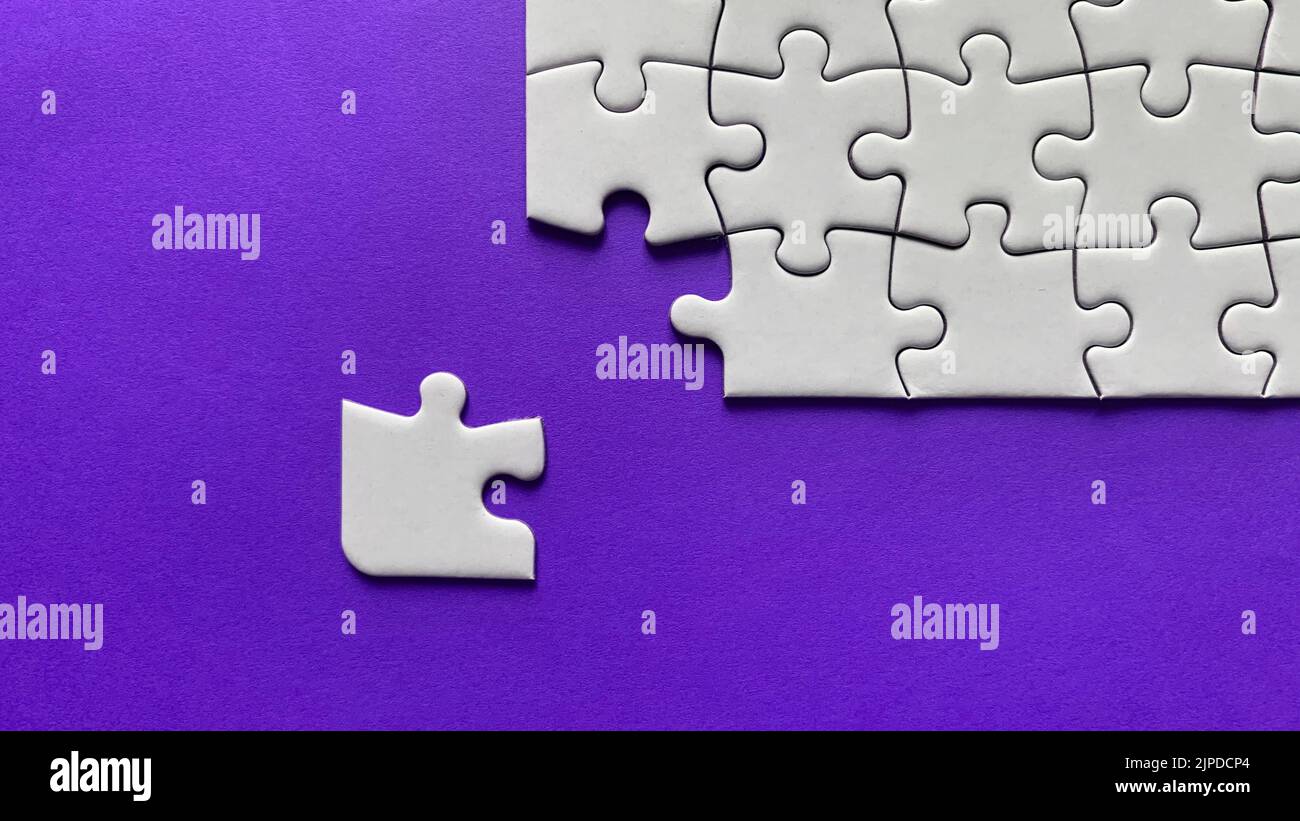 Jigsaw puzzle on purple background with customizable space for text or ...
