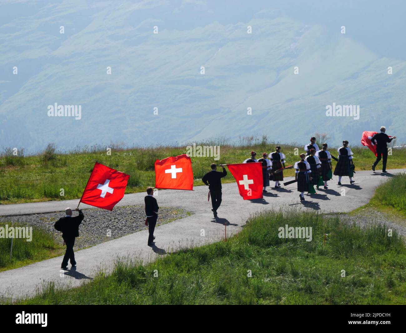 Swiss flag throwers walking at Mannlichen, Wengen, Bernese Oberland ...