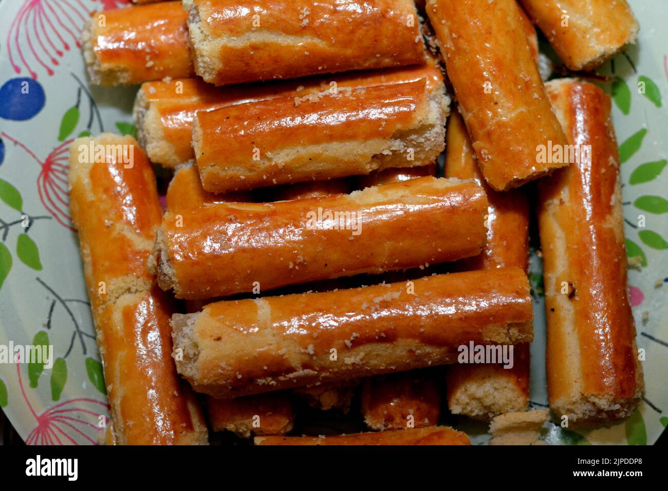 A closeup of Arabian pastry of finger shaped cookies stuffed and filled ...