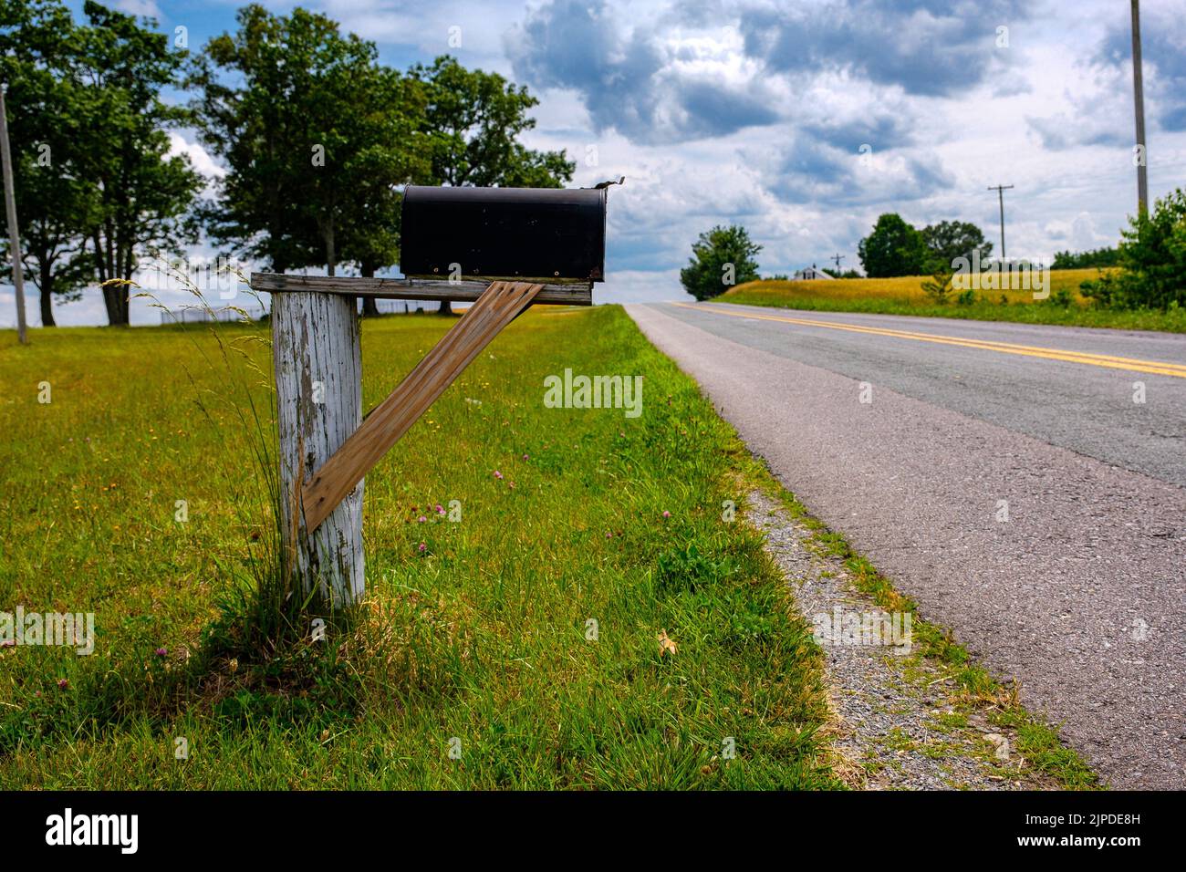 Country road with mailbox and blue sky Stock Photo - Alamy