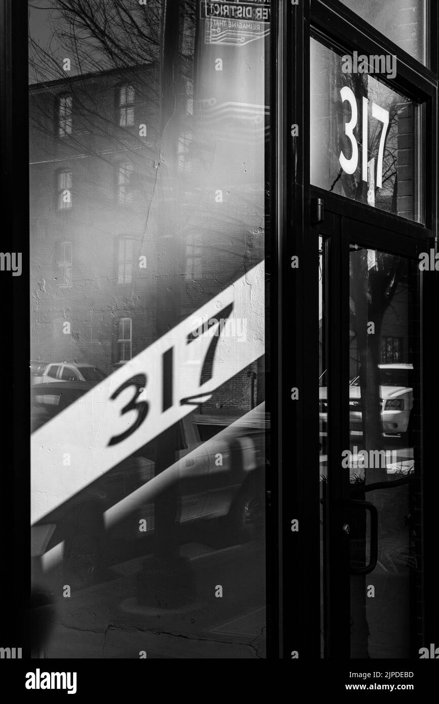 Reflections in a window of the number 317 B&W image Stock Photo - Alamy