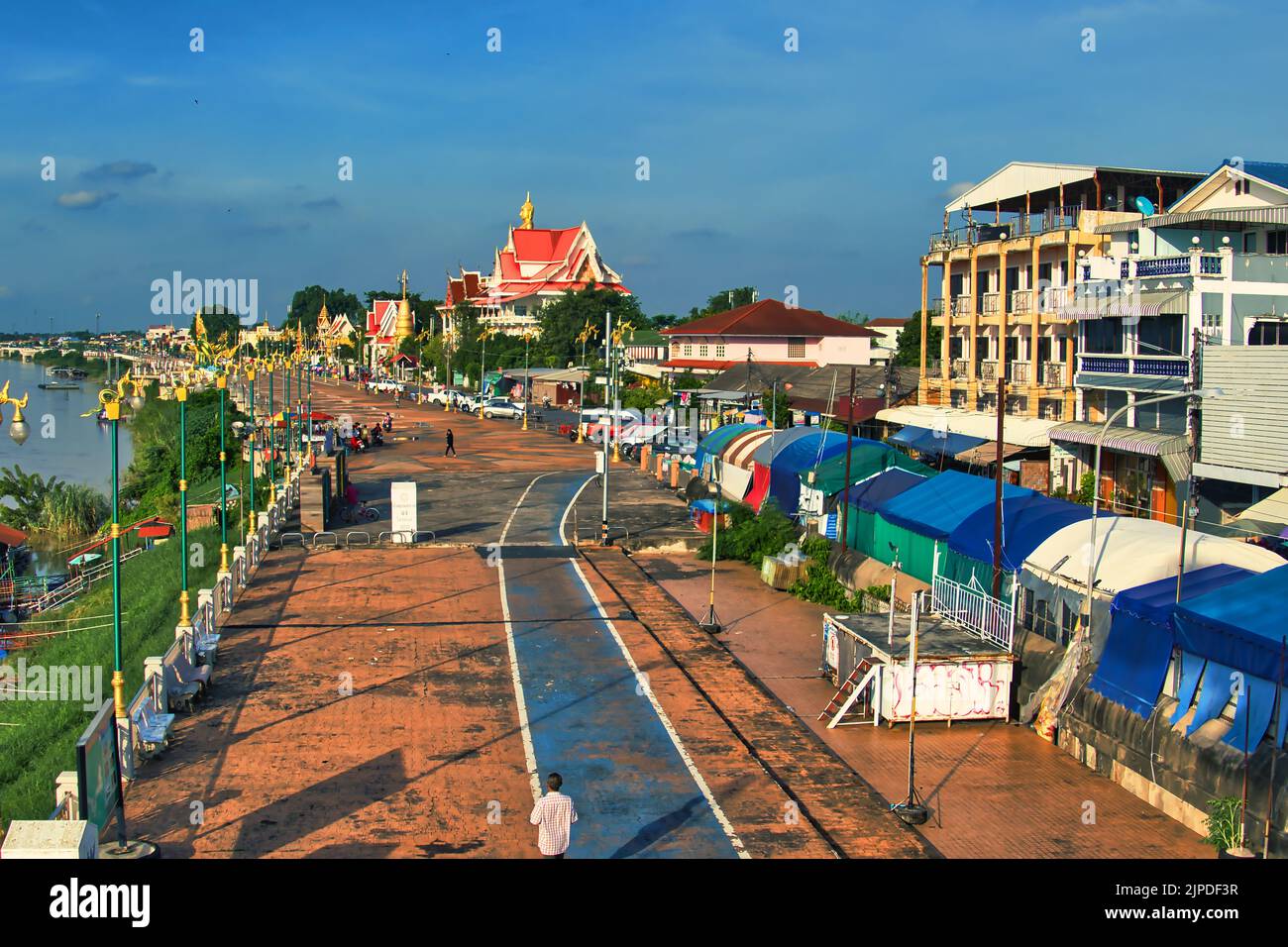 The boulevard along the Mekong River in Nong Khai, Thailand. Cityscape with market stalls ...
