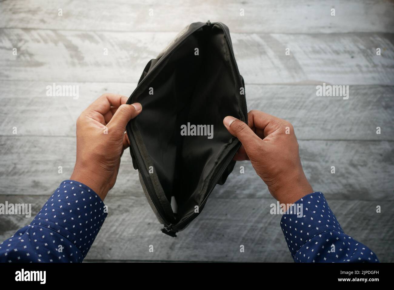 young man searching something in a shoulder bag Stock Photo - Alamy