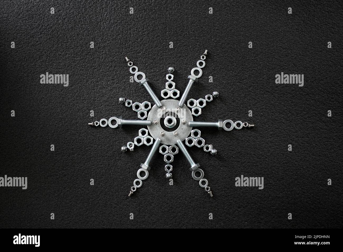 Metal art. Flower from bolts and washers on black background Stock ...