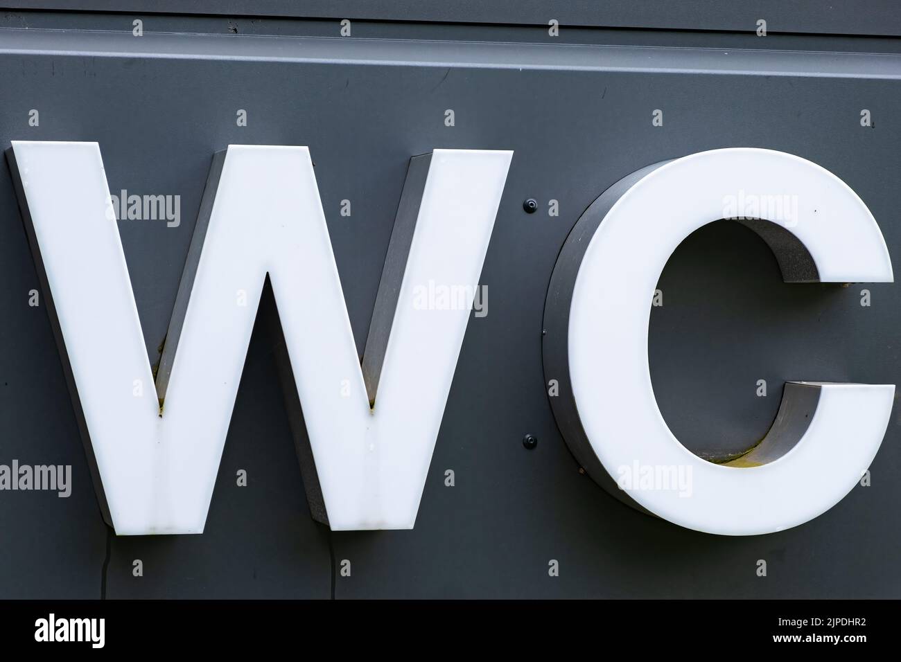 WC sign on the wall for the restroom or toilet Stock Photo - Alamy