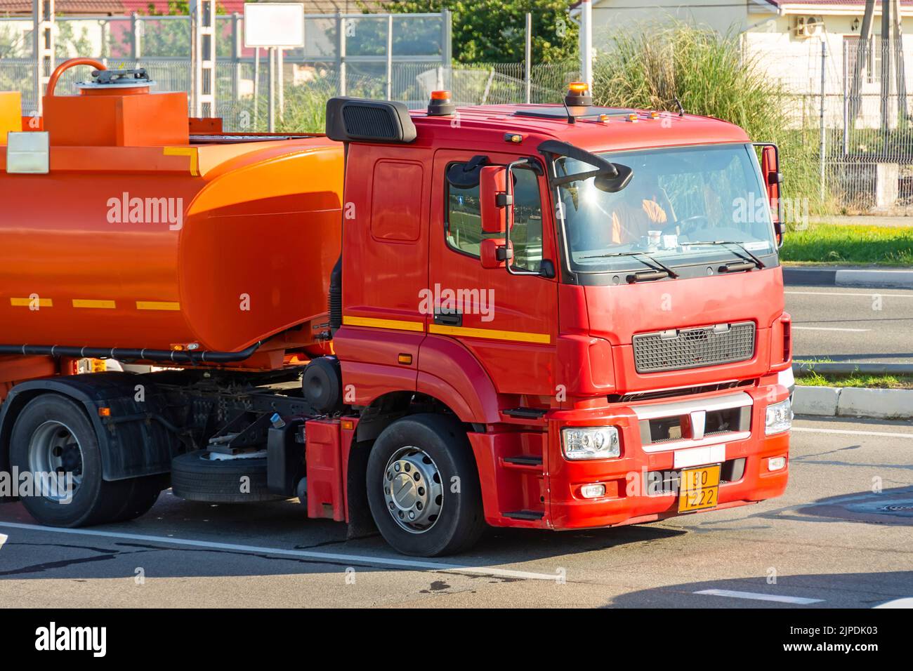 Big metal red fuel tanker truck shipping fuel on the countryside road ...