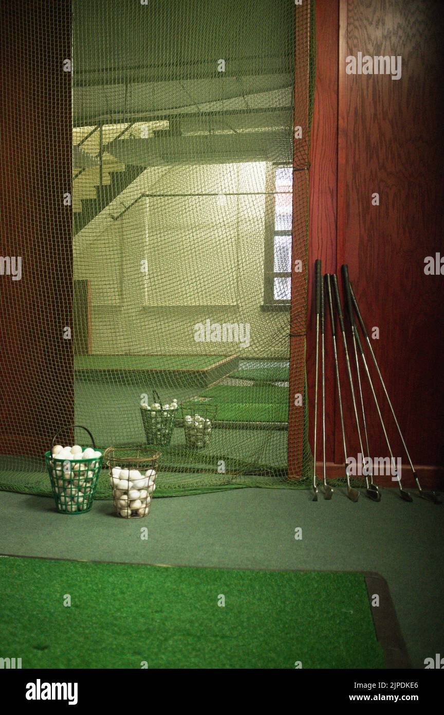 A vertical shot of a golf practice room with irons and golf balls Stock ...