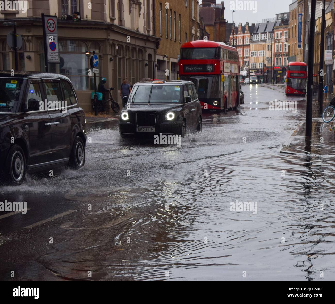 London, England, UK. 17th Aug, 2022. Buses and taxis splash through a ...