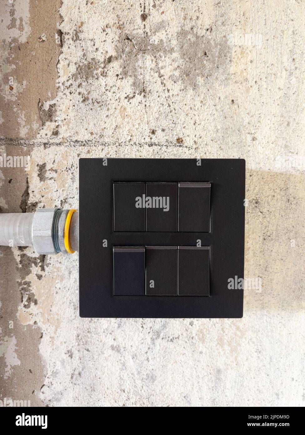 The light switch in the modern style is turned on on the concrete wall ...