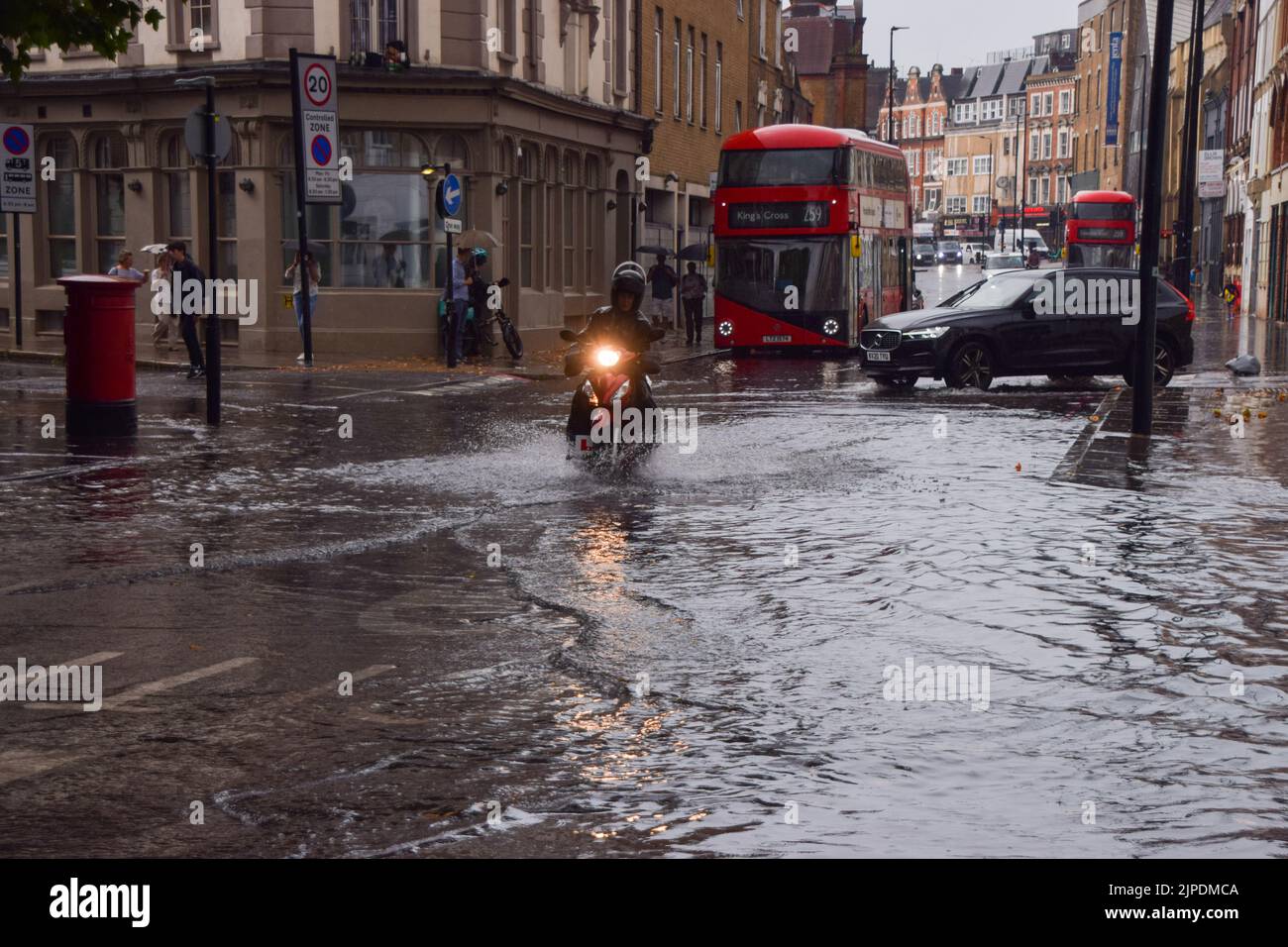 London England Uk 17th Aug 2022 A Motorcycle Splashes Through A