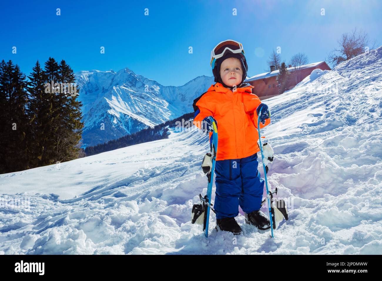 Boy with ski ready for skiing school stand over mountain Stock Photo ...