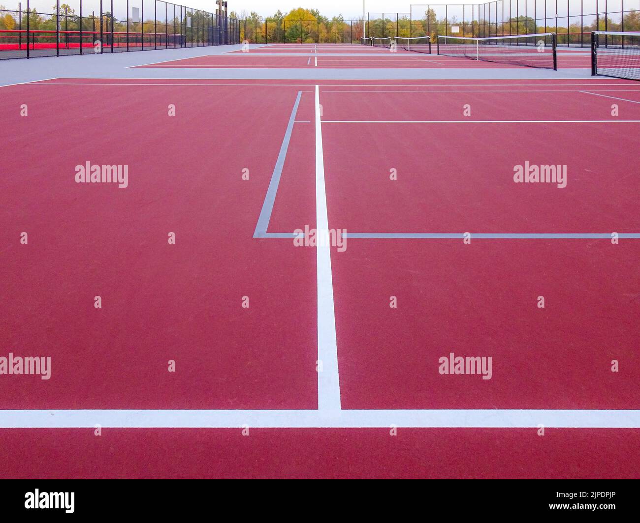 New red outdoor tennis courts with combined gray pickleball lines Stock ...