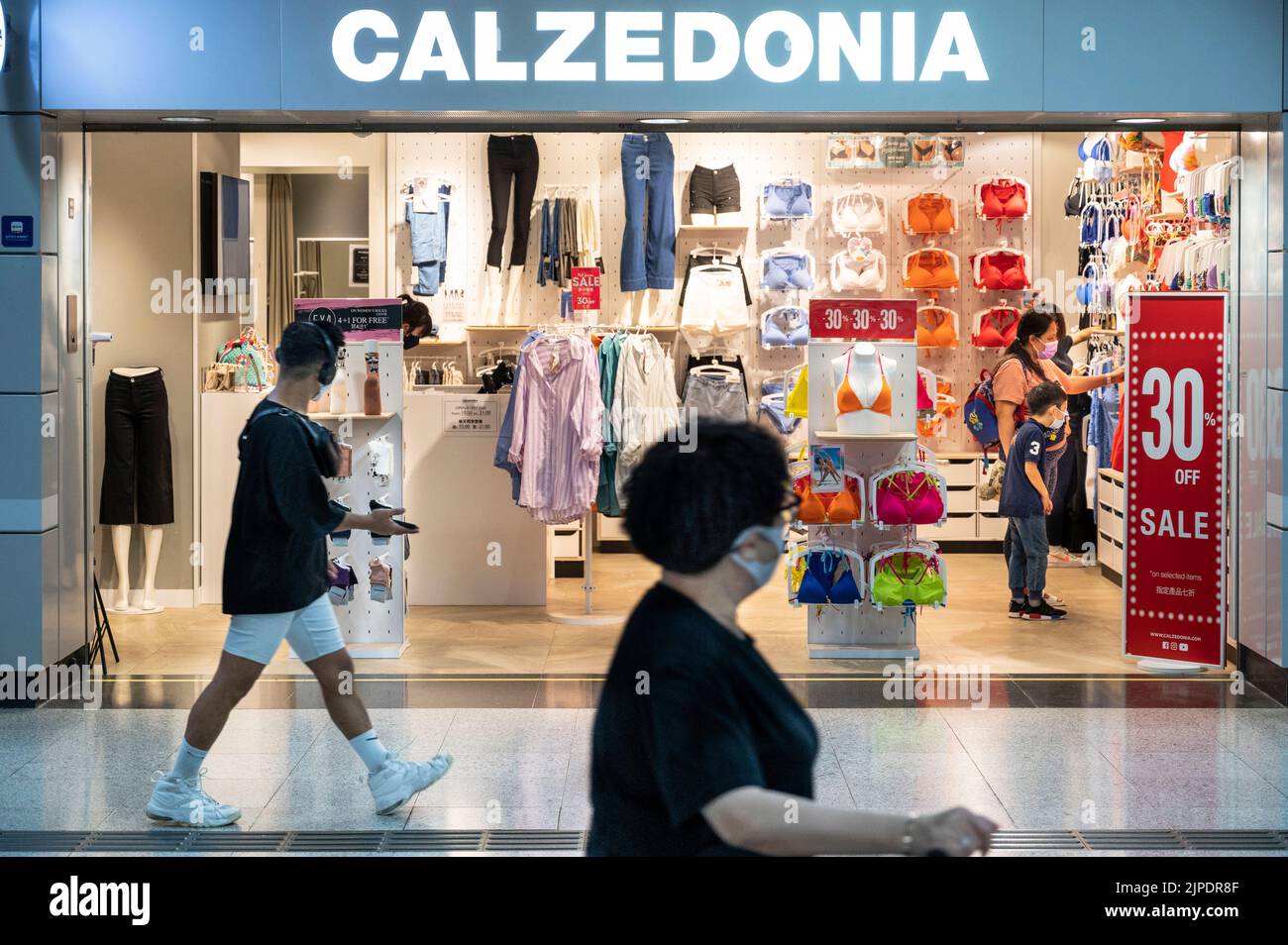Hong Kong, China. 10th Aug, 2022. Shoppers walk past the Italian ...