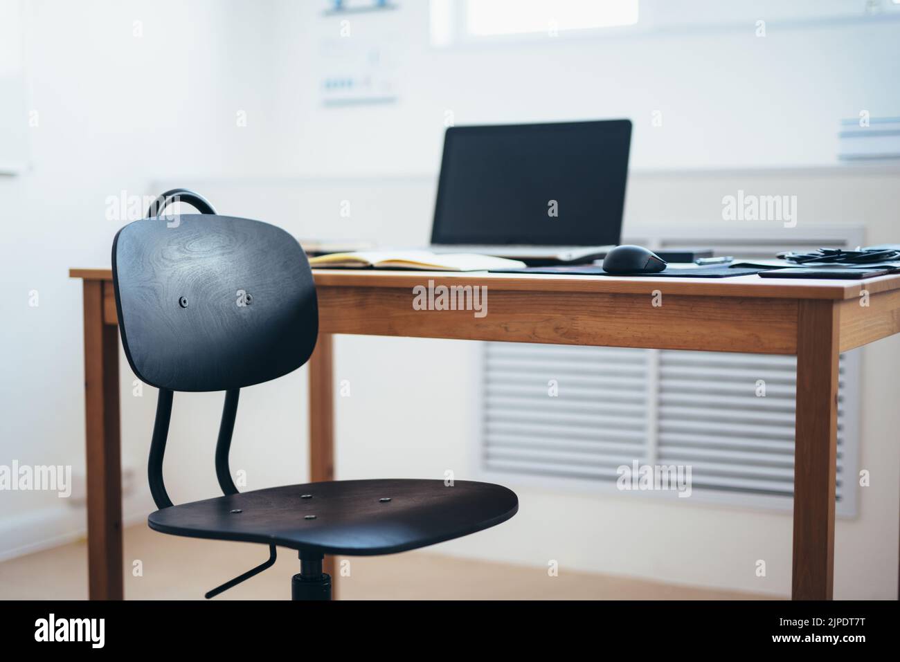 Empty work space chair, desk with laptop Stock Photo - Alamy