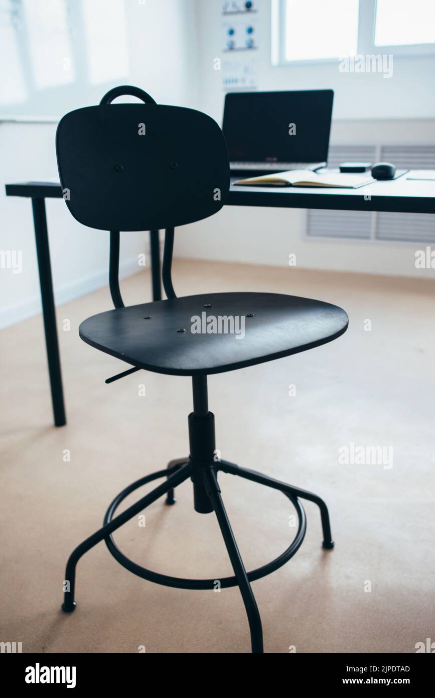 Empty work space chair, desk with laptop Stock Photo - Alamy