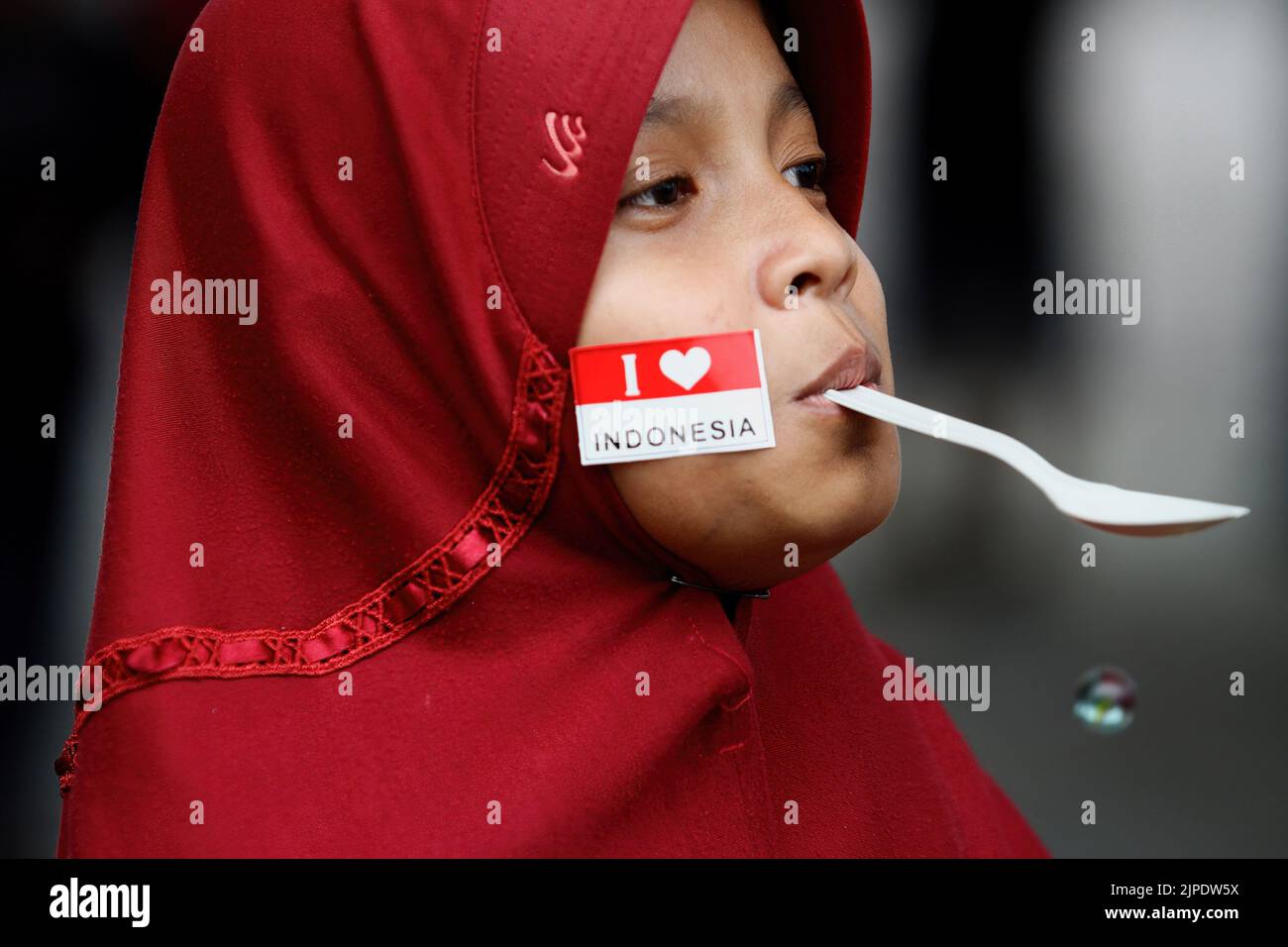 A girl takes part in the marbles racing competition or locally known as ...