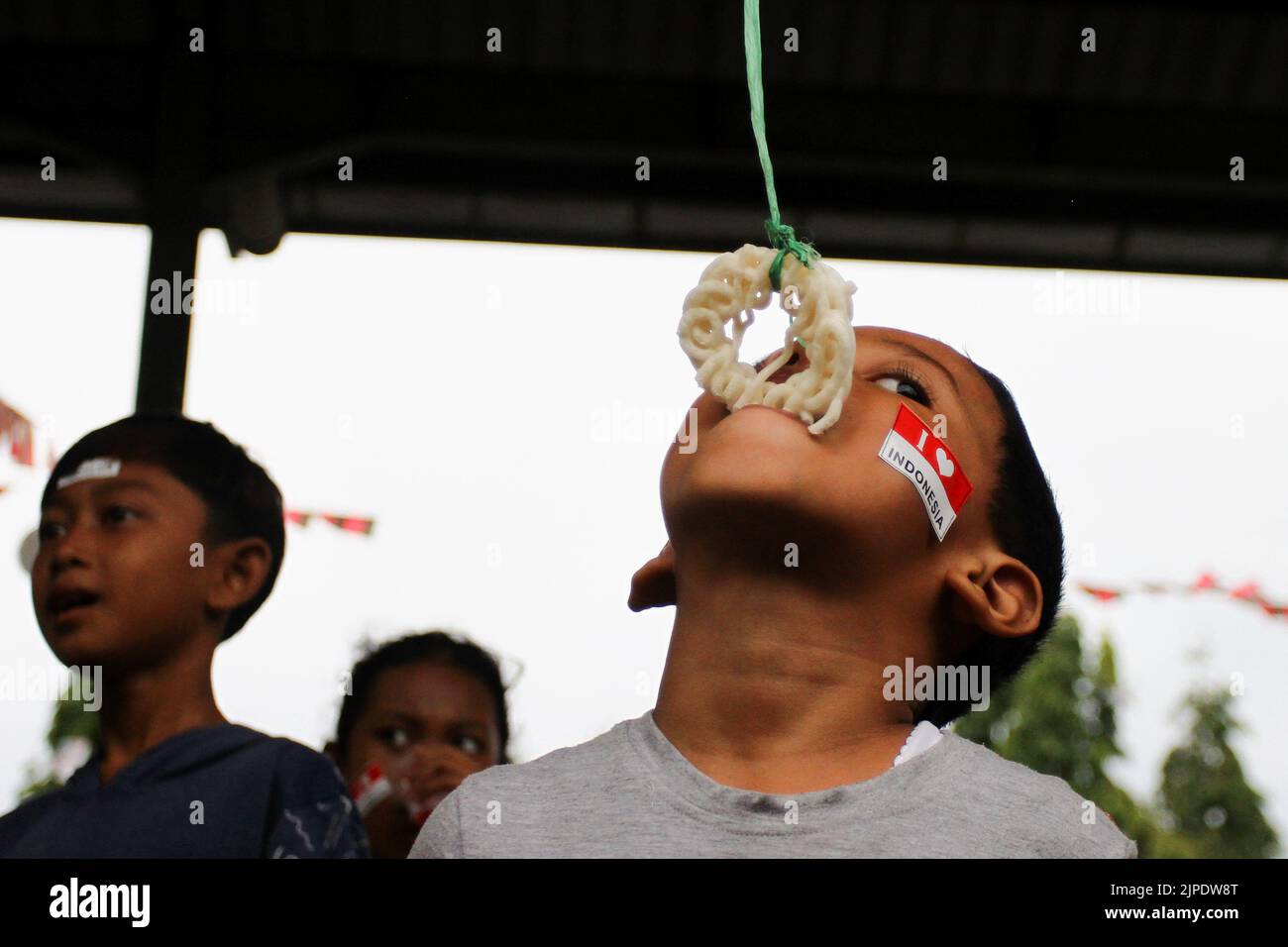 Children take part in a cracker eating competition or locally known as ...