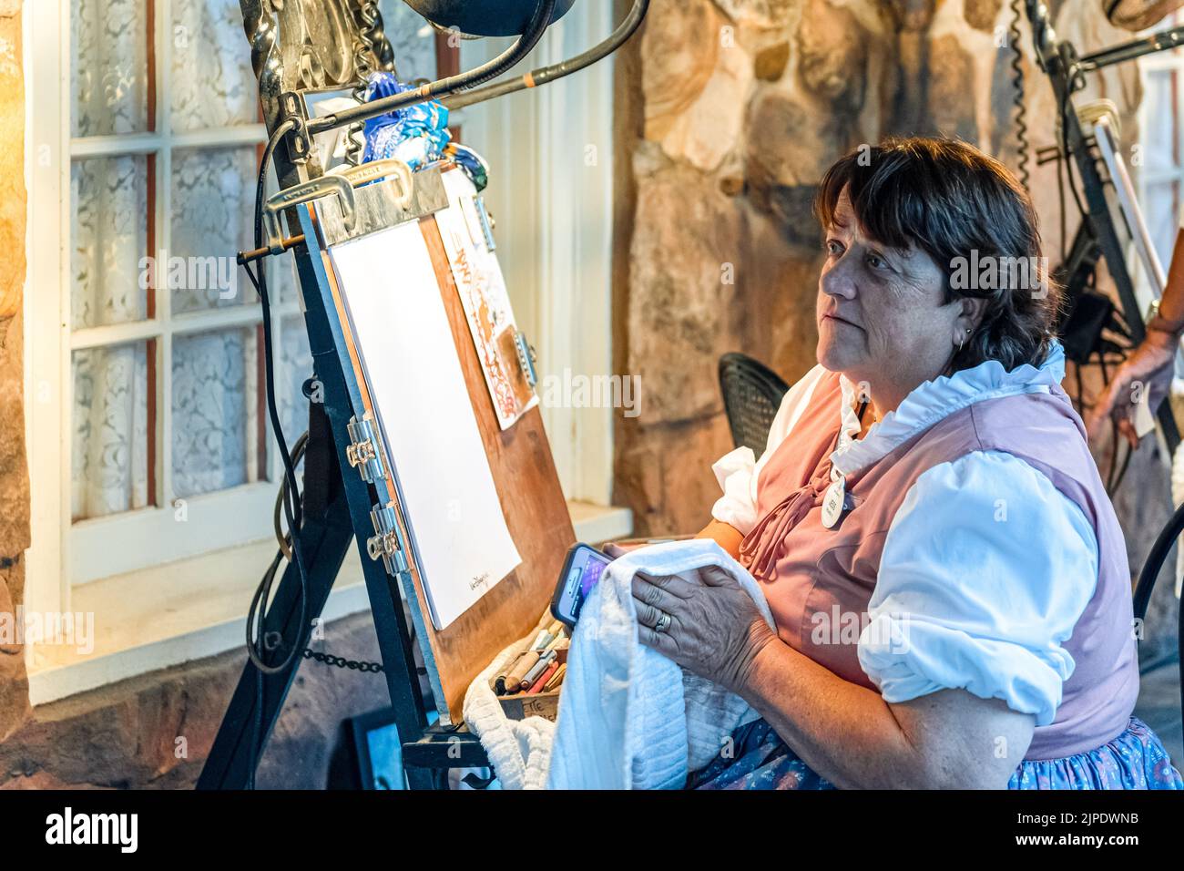 A female cartoonist working at night in the porch of a building Stock ...