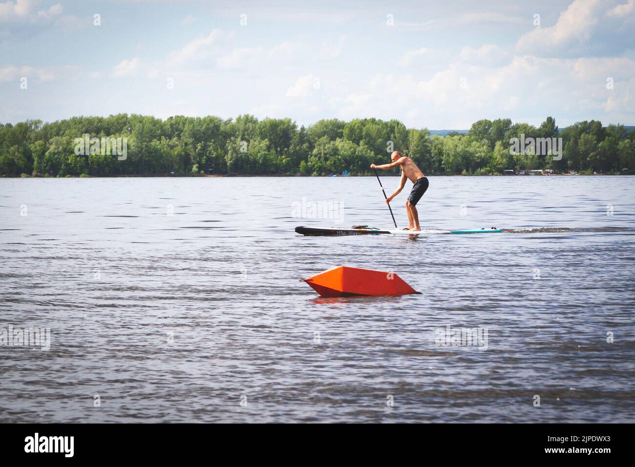 Sap surfing. Surf training. Men, friends ride SUP boards on a big river ...