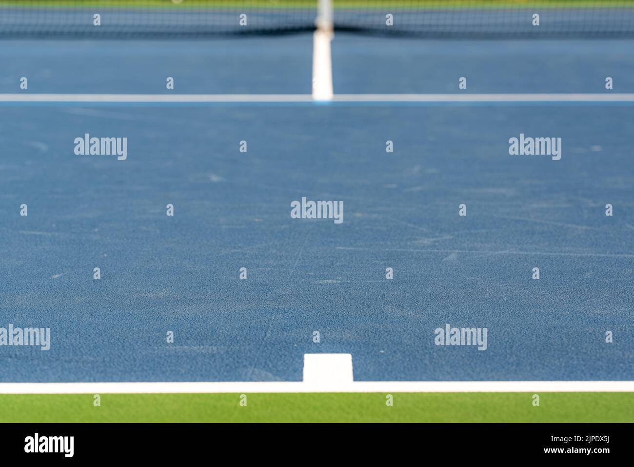 Close up photo of the center mark at the baseline of a new outdoor blue ...