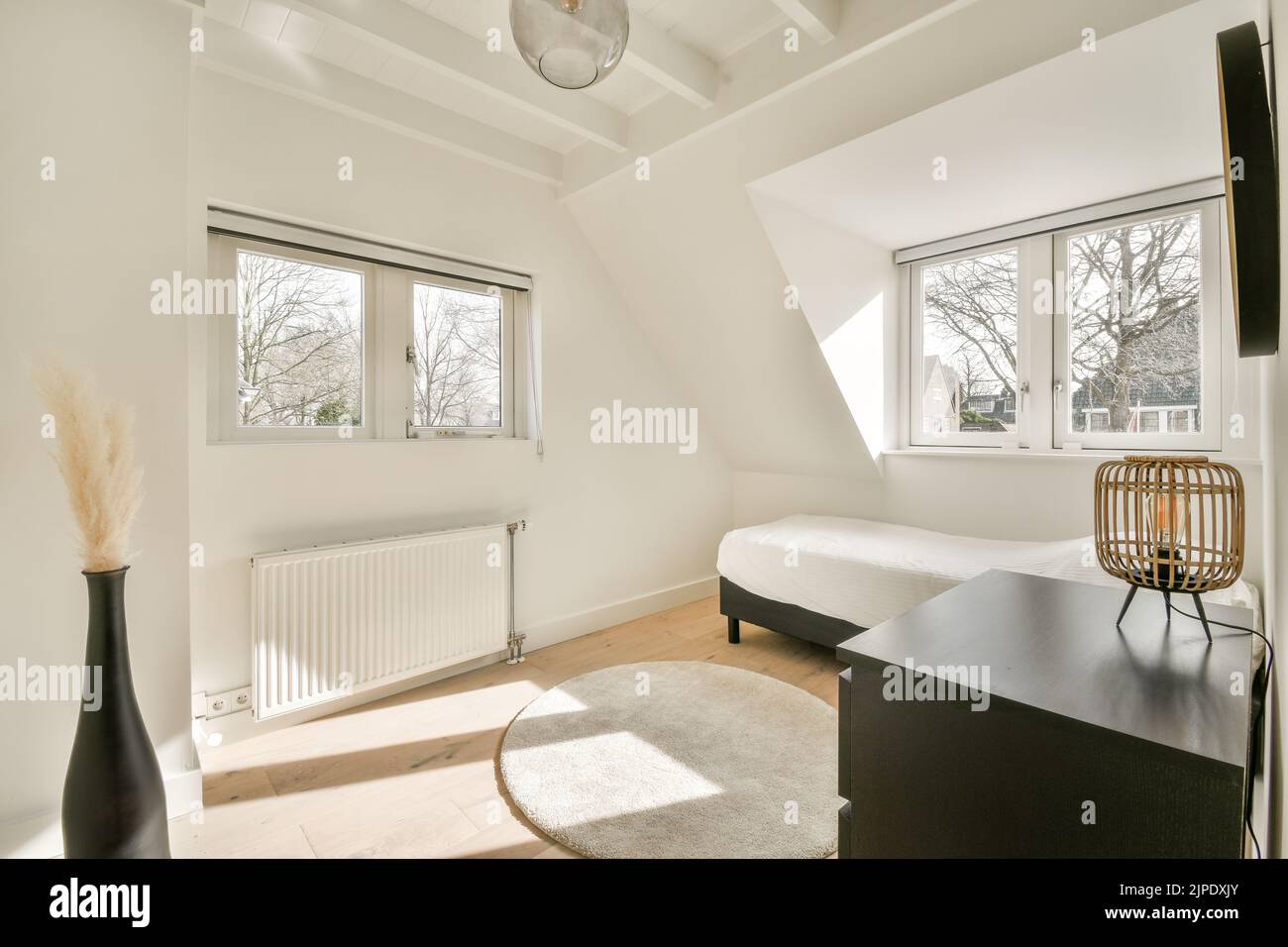 Comfortable bed placed near green wall in modern minimalist style ...