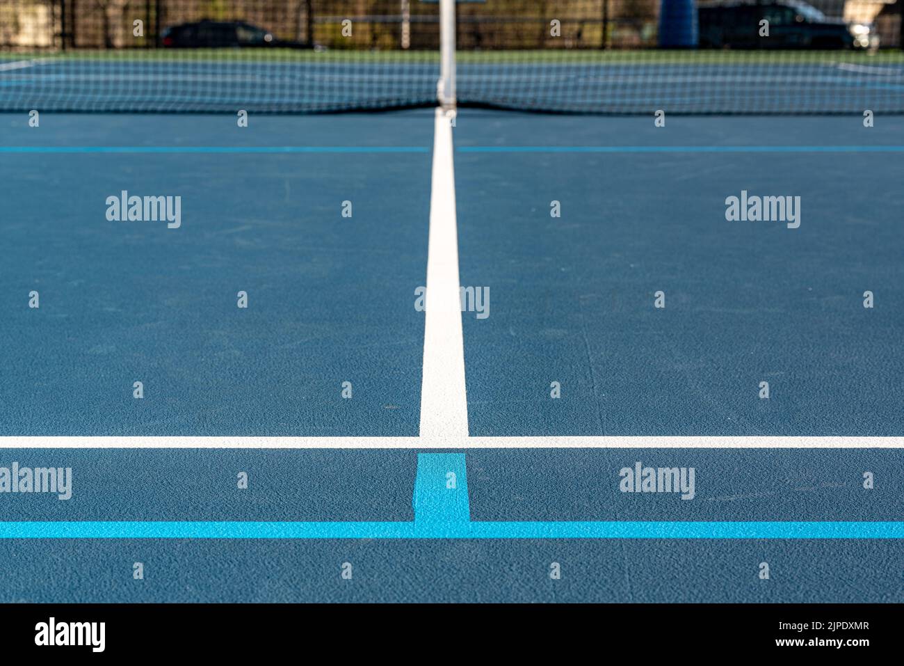 Close up photo of new outdoor blue tennis court with light blue ...