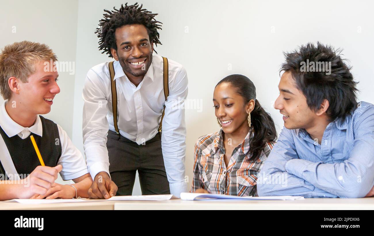 Teenage Students, friendly teacher. A friendly smile from a class tutor ...