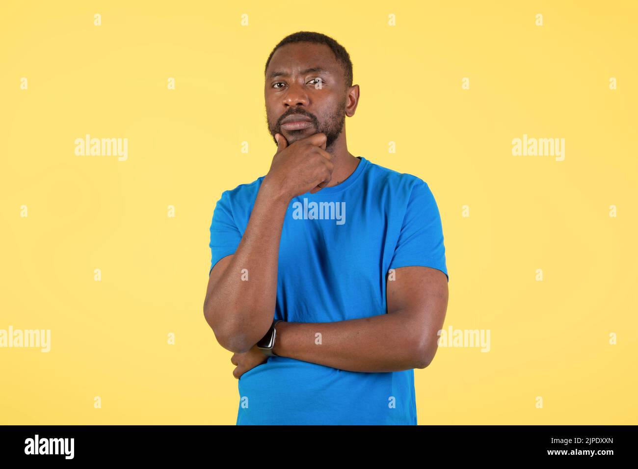 Portrait Of Thoughtful Black Guy Thinking Touching Chin, Yellow ...