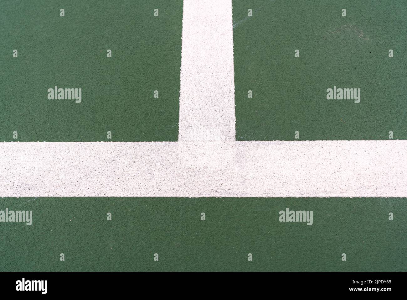 New outdoor green tennis courts with white lines and gray out of bounds ...