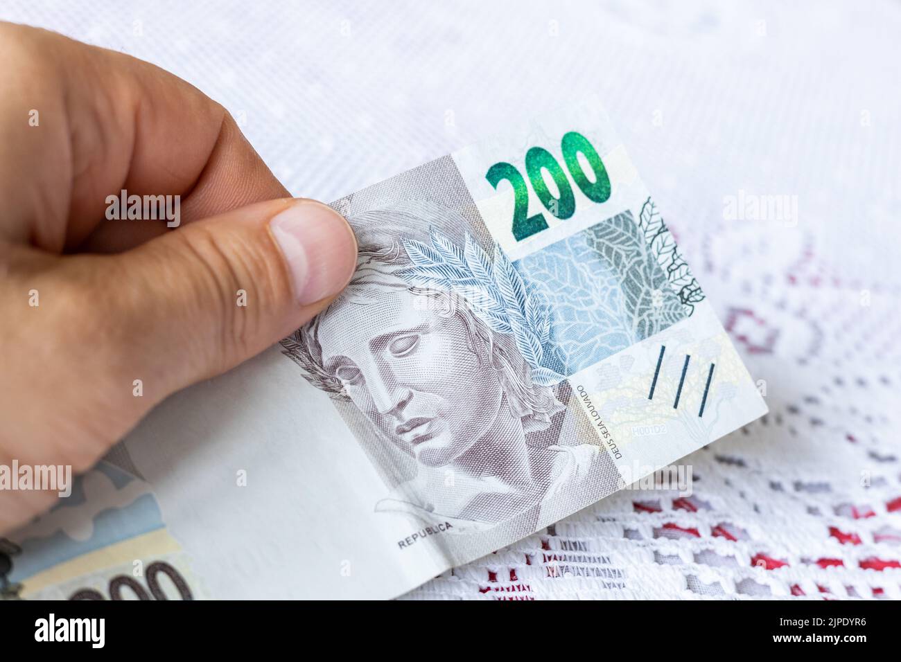 Brazil highest banknote, 200 Reais, held in your hand Stock Photo - Alamy