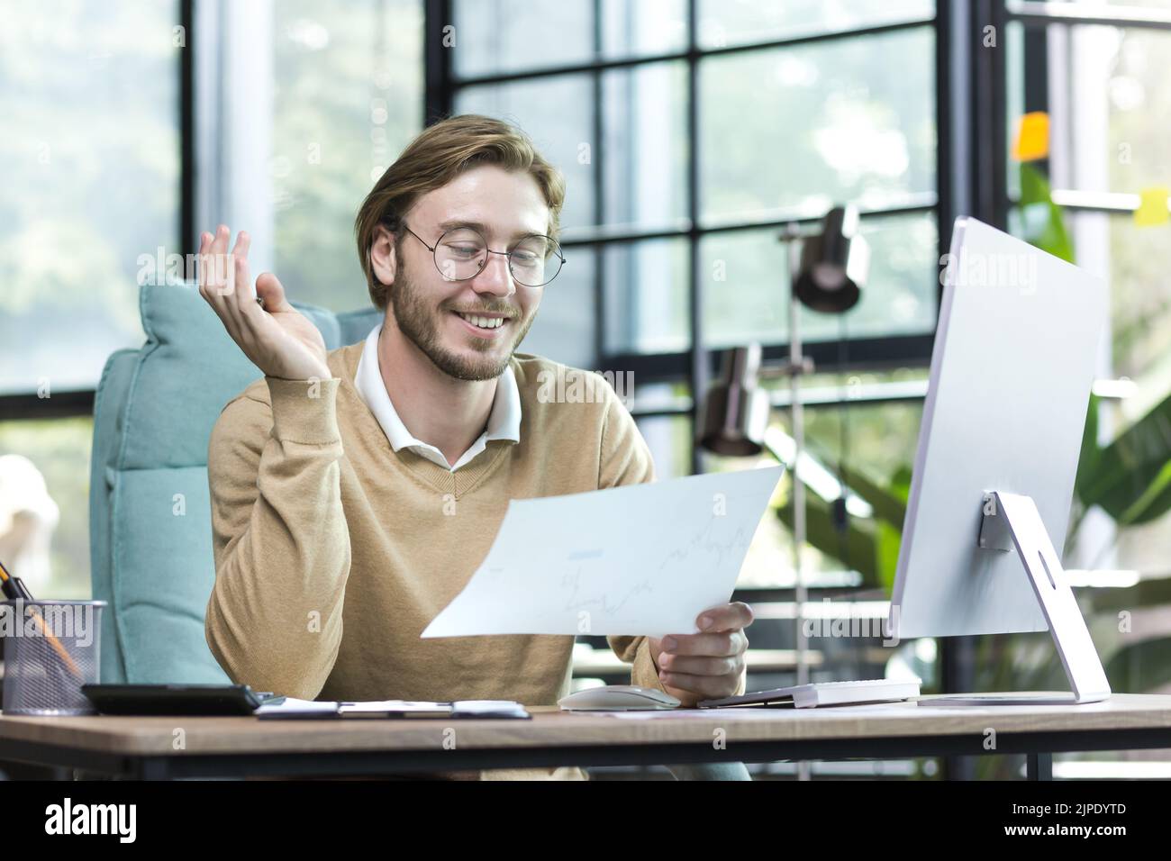 Happy blond man working inside an office building, young financier ...