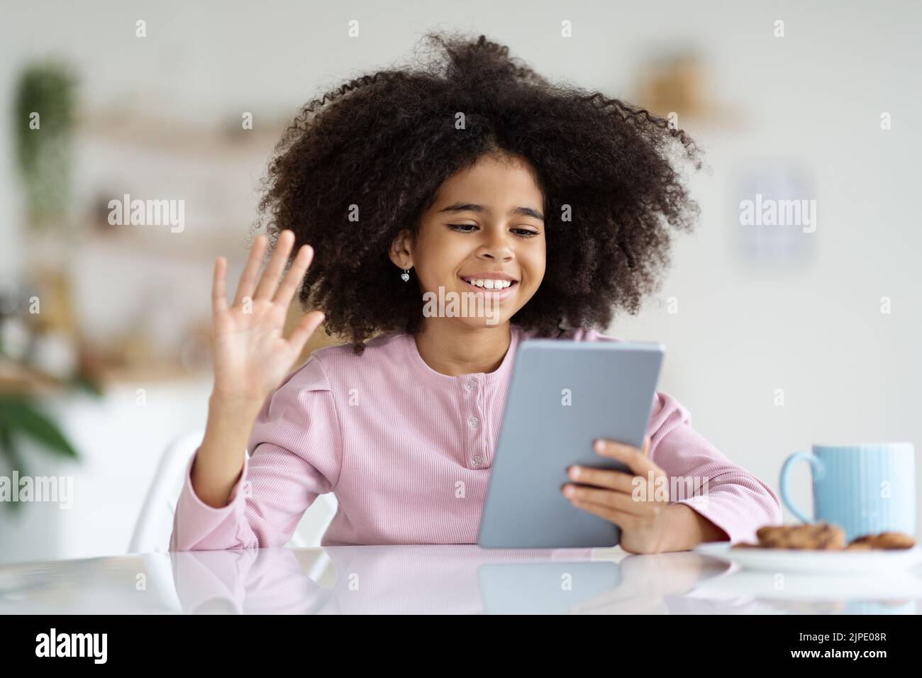 Cheerful african american girl having video call with friend Stock ...