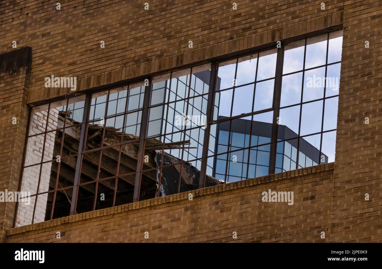Close up of modern architect seen through an old abondoned shell of a ...