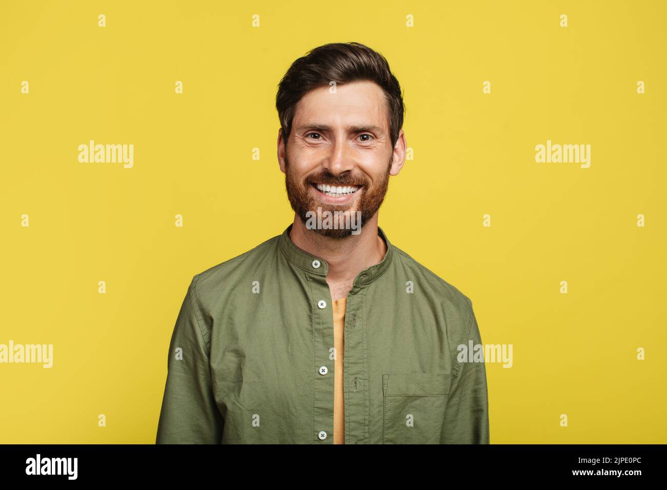 Portrait of happy middle aged man posing and smiling at camera over ...