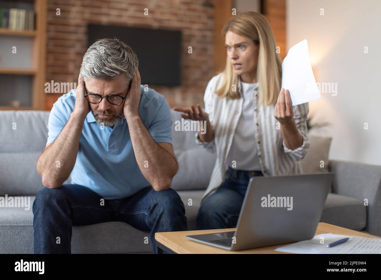 Despaired old caucasian couple work with documents, laptop, pay taxes ...