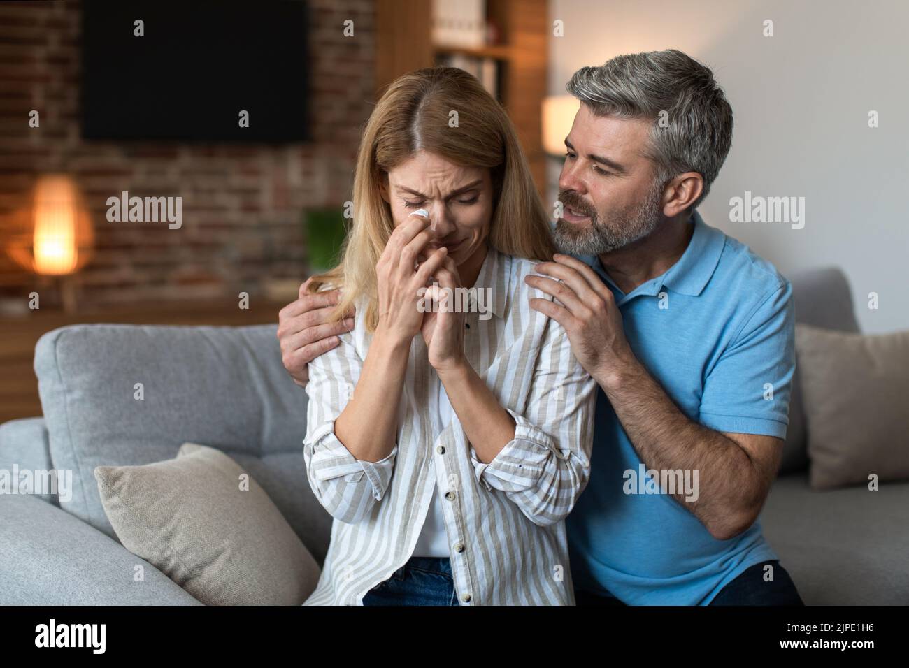 Woman husband hug sad hi-res stock photography and images - Alamy