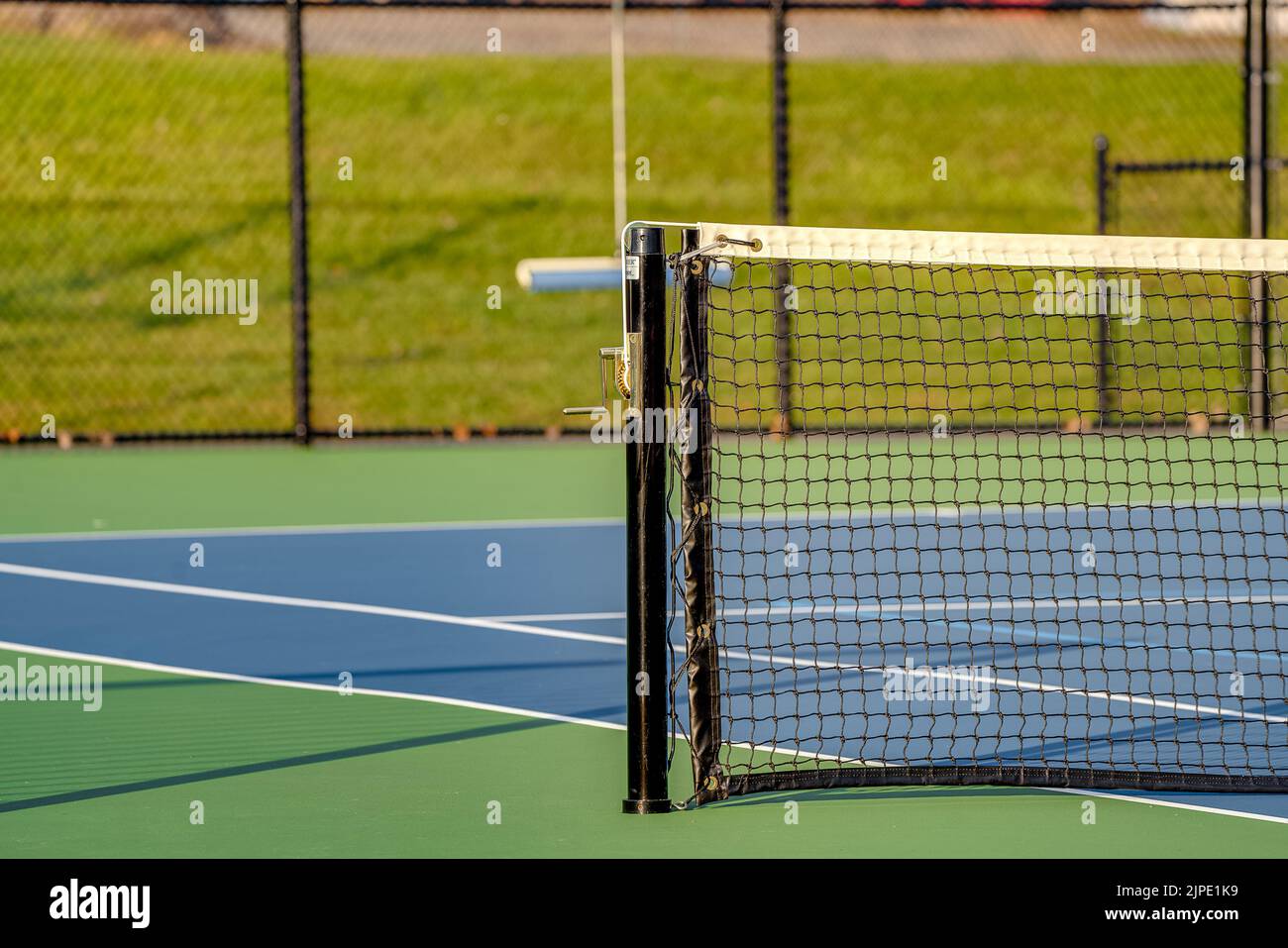 Afternoon close-up photo of new blue outdoor tennis court, light blue ...